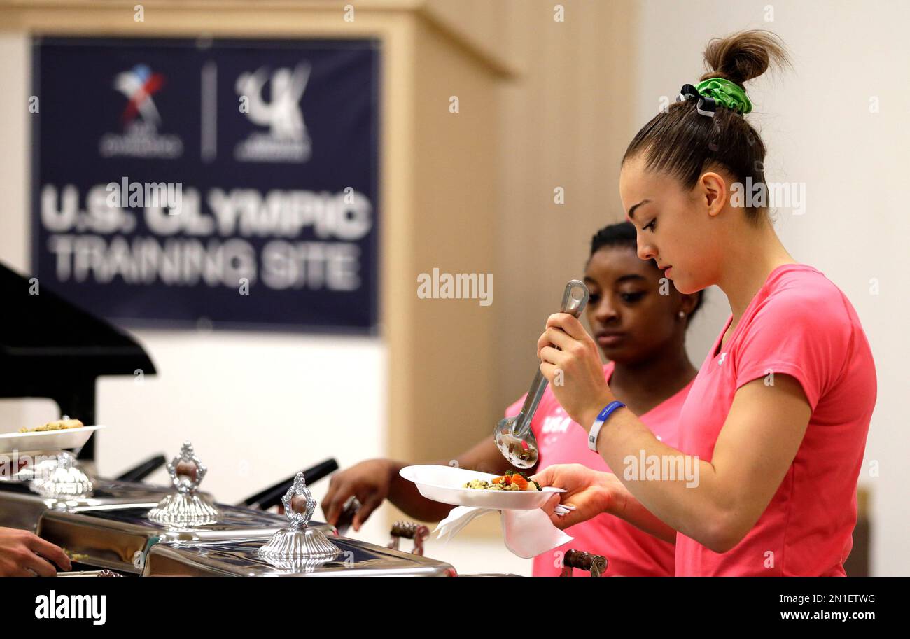 U.S. gymnast Maggie Nichols, right, goes through the buffet line after ...