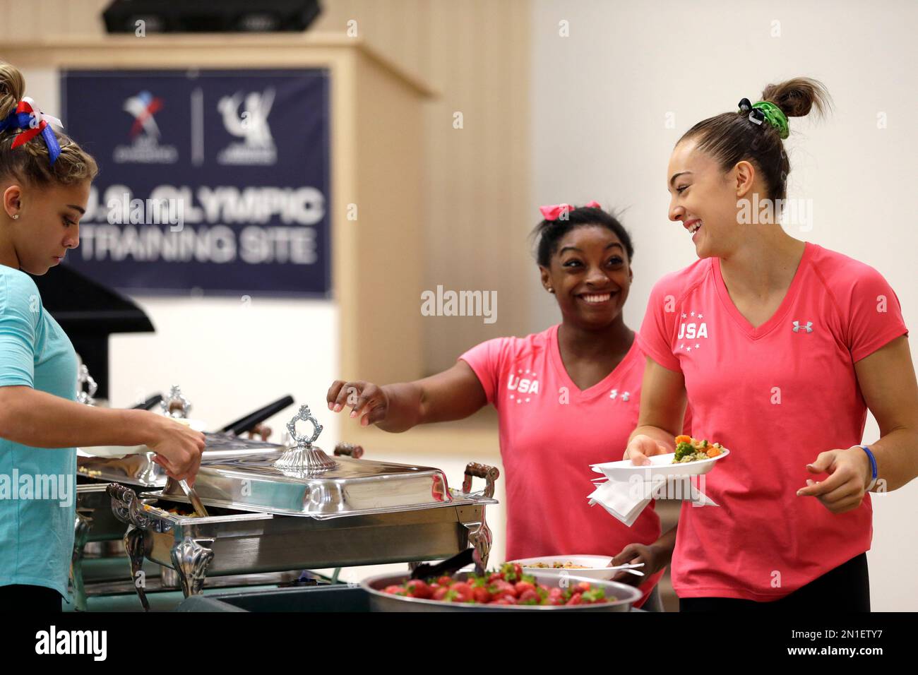 U.S. gymnasts Maggie Nichols, right, and Simone Biles, center, go ...