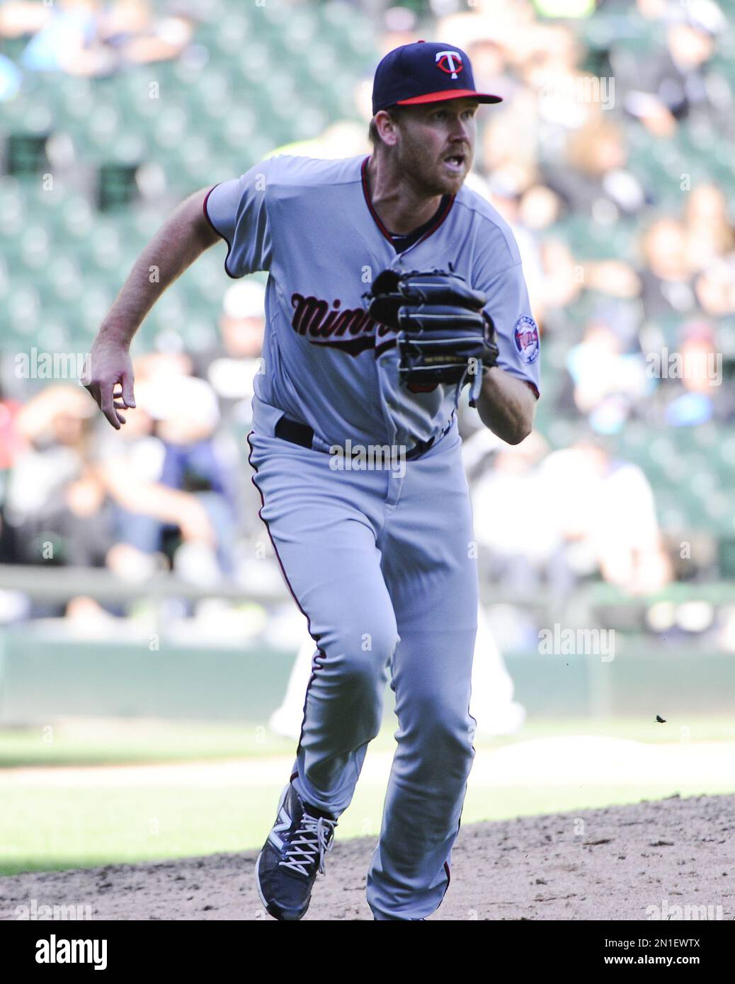Minnesota Twins relief pitcher Michael Tonkin (59) chases down a ball ...