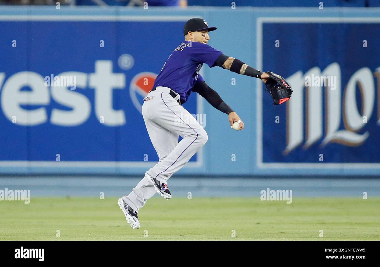 Colorado Rockies right fielder Carlos Gonzalez throws the ball against ...
