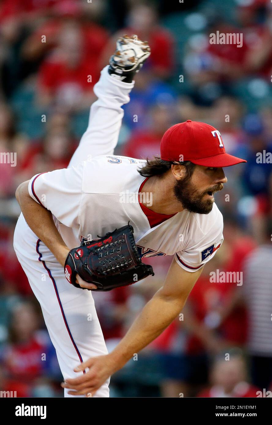 Texas Rangers starting pitcher Cole Hamels follows through on his ...