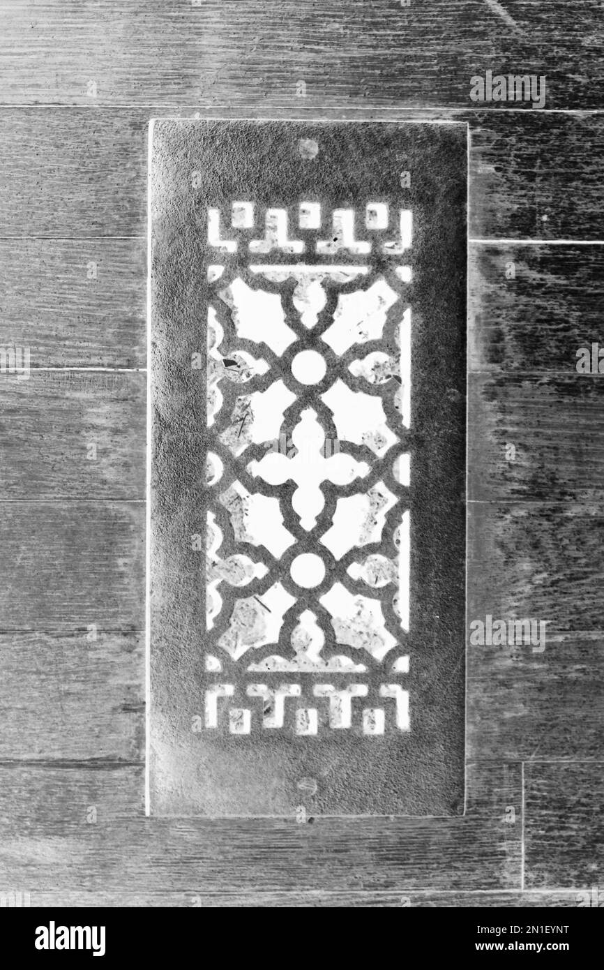 Antique medieval metal floor grate with a decorative repeating pattern ...