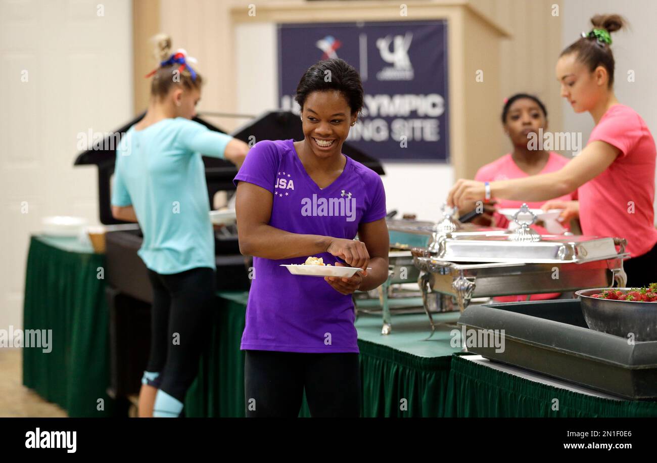 U.S. gymnast Gabby Douglas goes through the buffet after a training ...