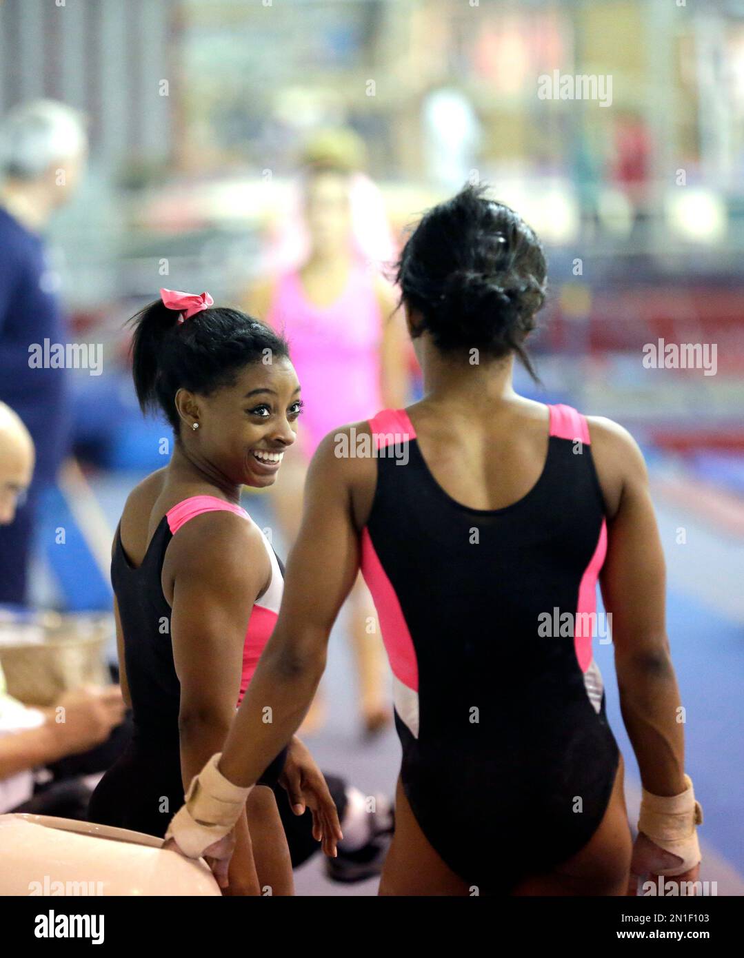 U.S. gymnast Simone Biles, left, smiles as she talks with Gabby Douglas ...