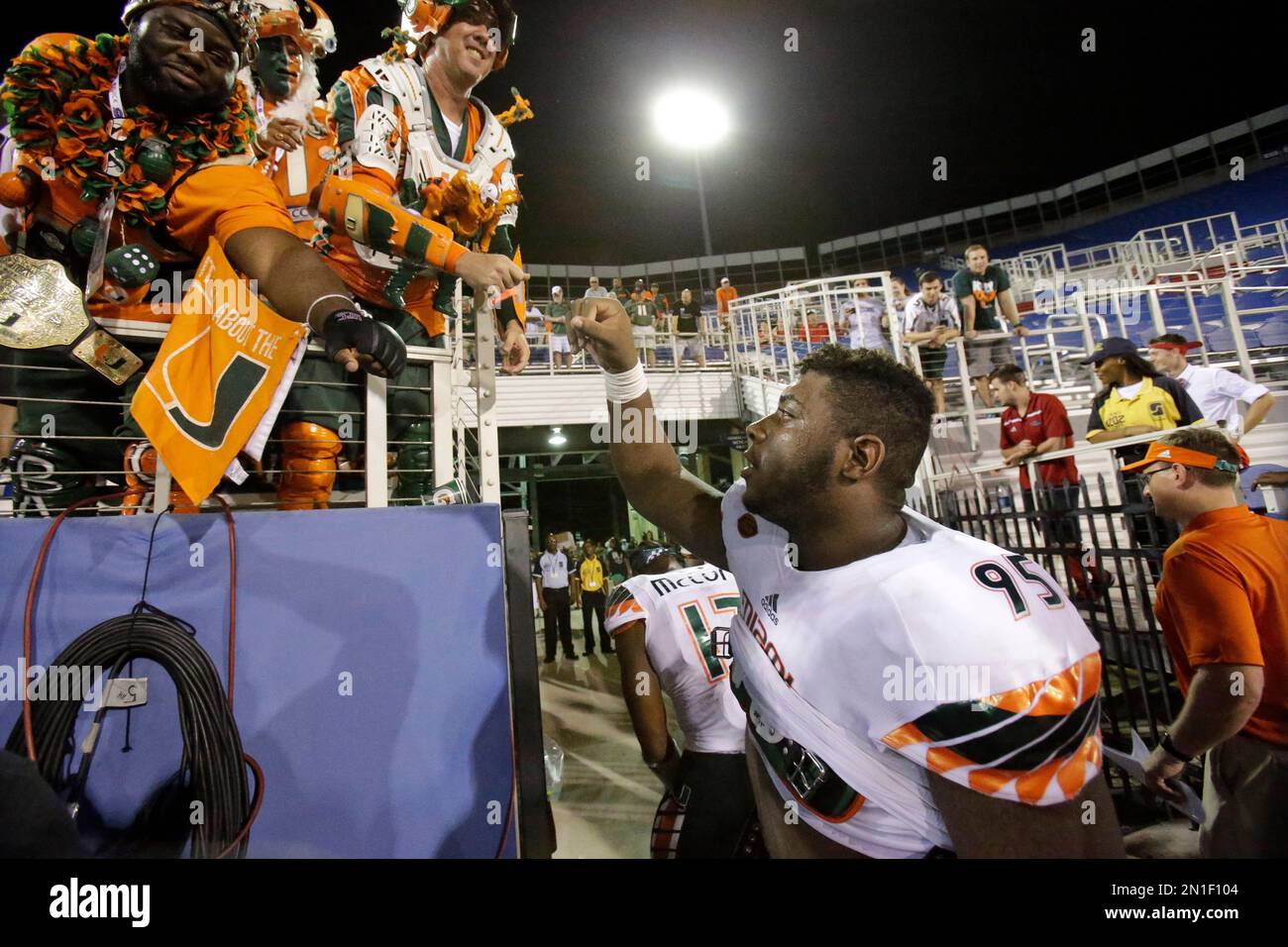 Miami defensive lineman Anthony Moten is congratulated by fans after an ...