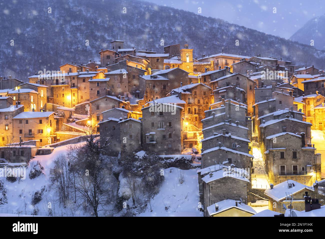 The illuminated medieval village of Scanno under snowfall, Abruzzo ...