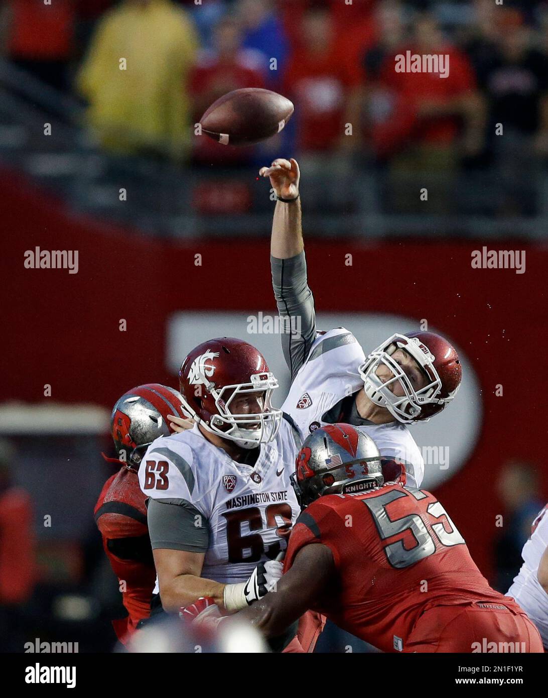 Washington State quarterback Luke Falk (4) is hit as he throws a pass ...