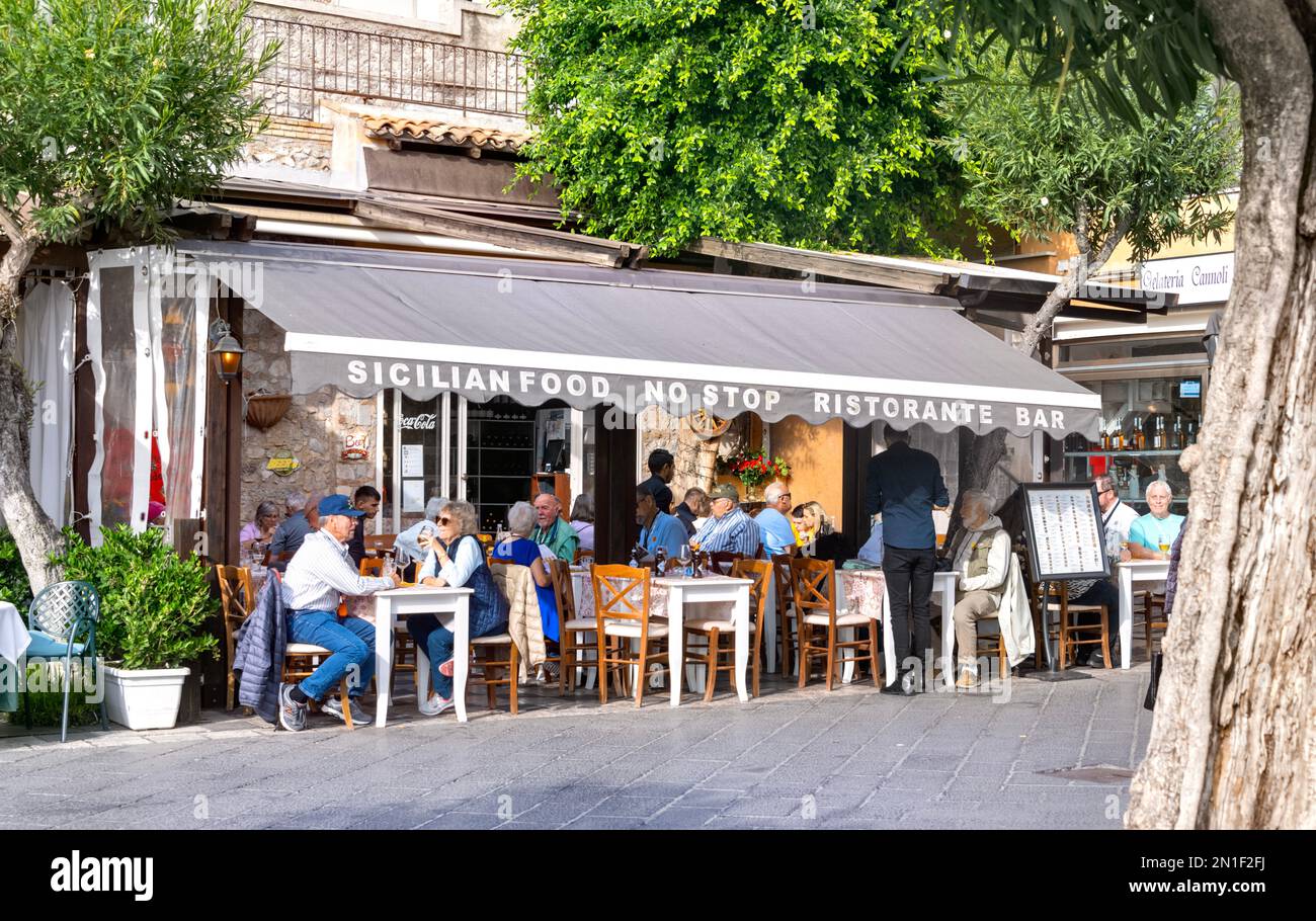 Taormina Sicily, italy, people sitting eating and drinking outside at ...