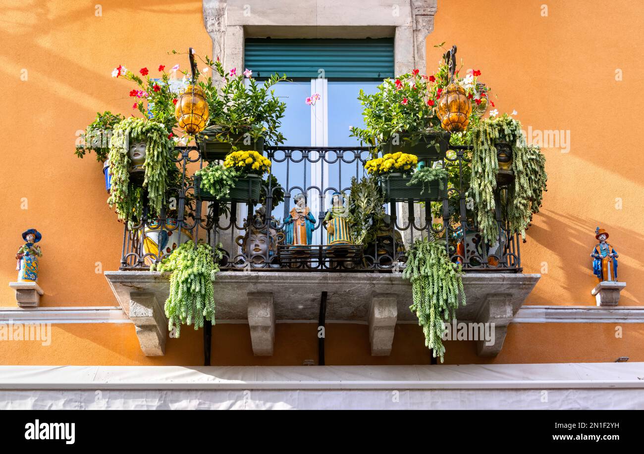Taormina Sicily, Italy wrought iron balcony festooned with colourful ...