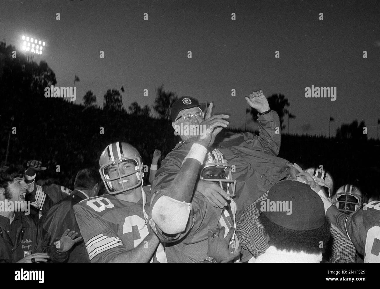 Coach Woody Hayes of the Ohio State Buckeyes is carried of the field by ...