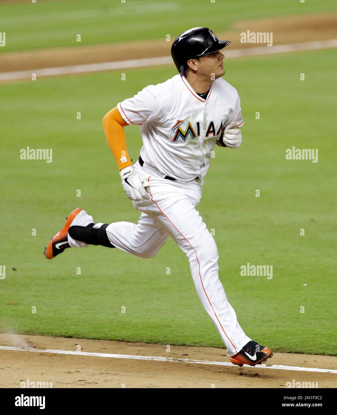 Miami Marlins' Miguel Rojas (19) heads to first base after hitting a ...