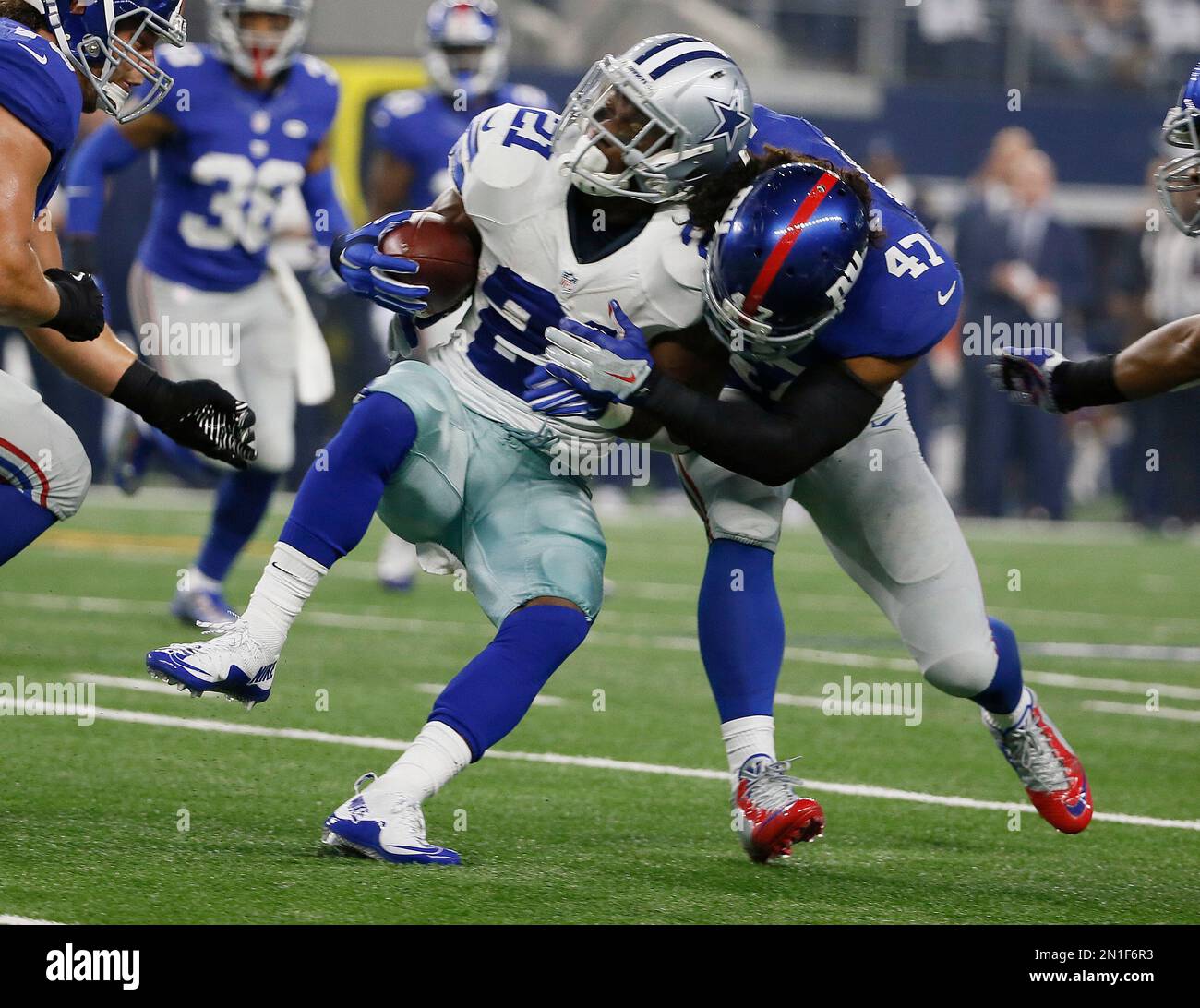 Dallas Cowboys running back Joseph Randle (21) is tackled by New York ...