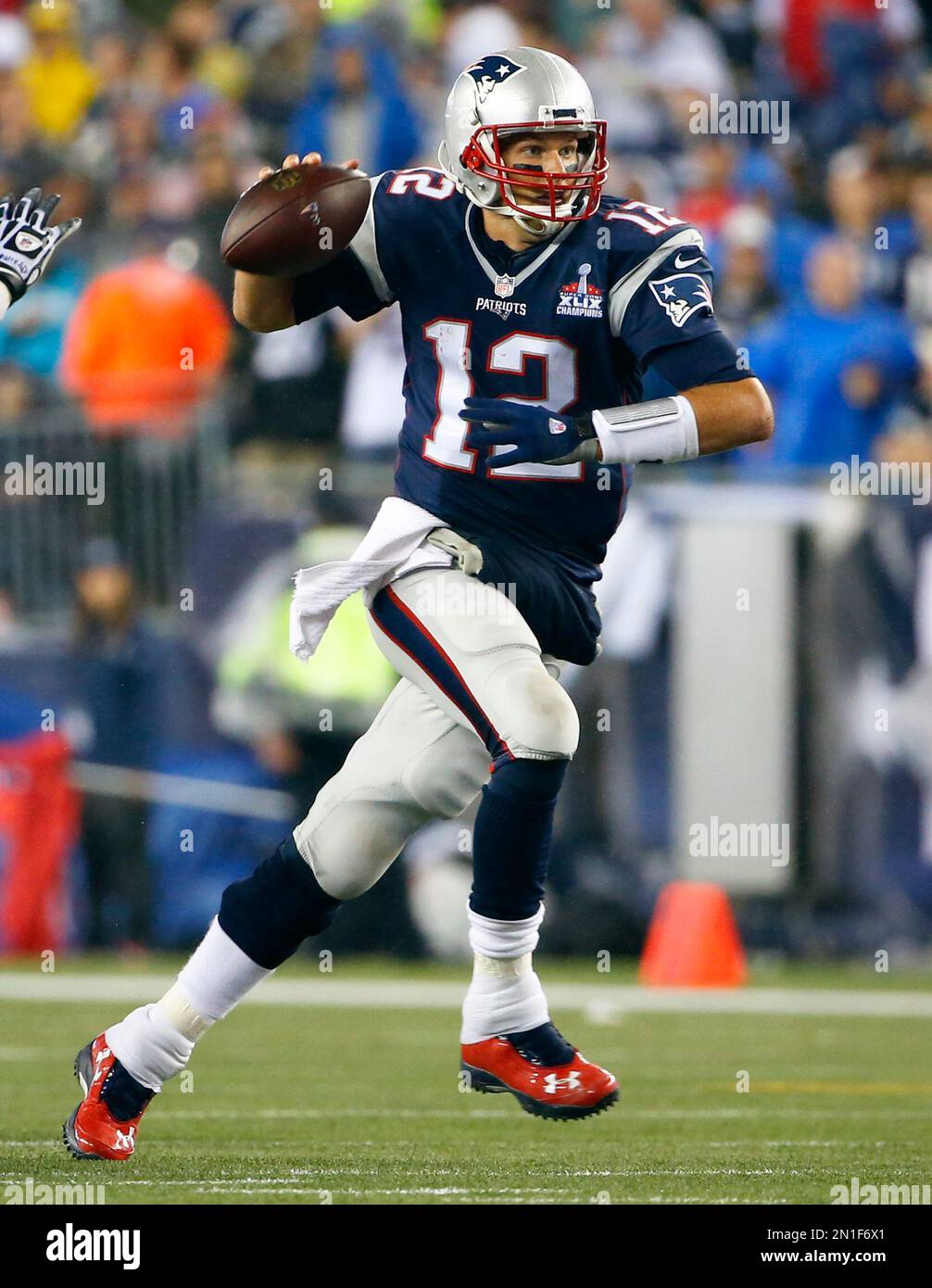 New England Patriots quarterback Tom Brady scrambles and looks for a ...