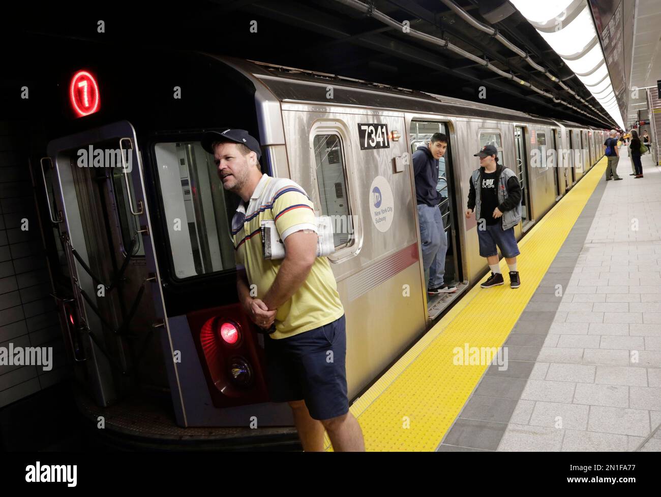 A subway rider peers down the newly completed tunnel that connects the ...