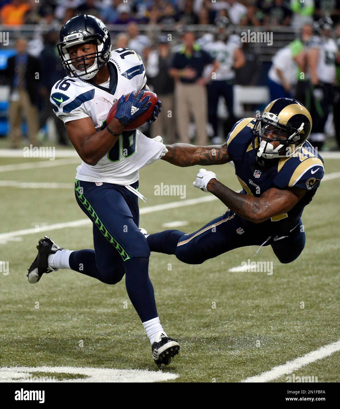 Seattle Seahawks' Tyler Lockett, left, catches a pass as St. Louis Rams ...