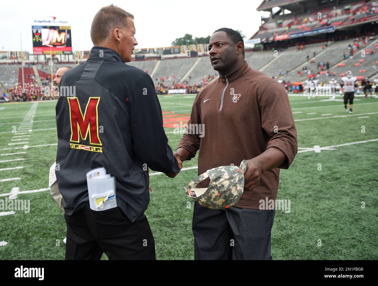 Bowling Green head coach Dino Babers, right, shakes hands with Maryland ...