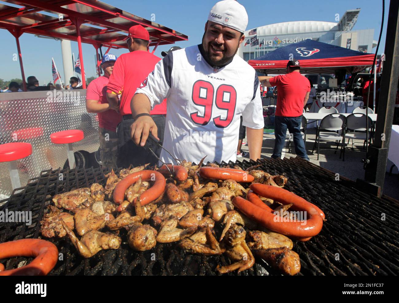 A fans grills in the parking lot before an NFL football game Sunday ...