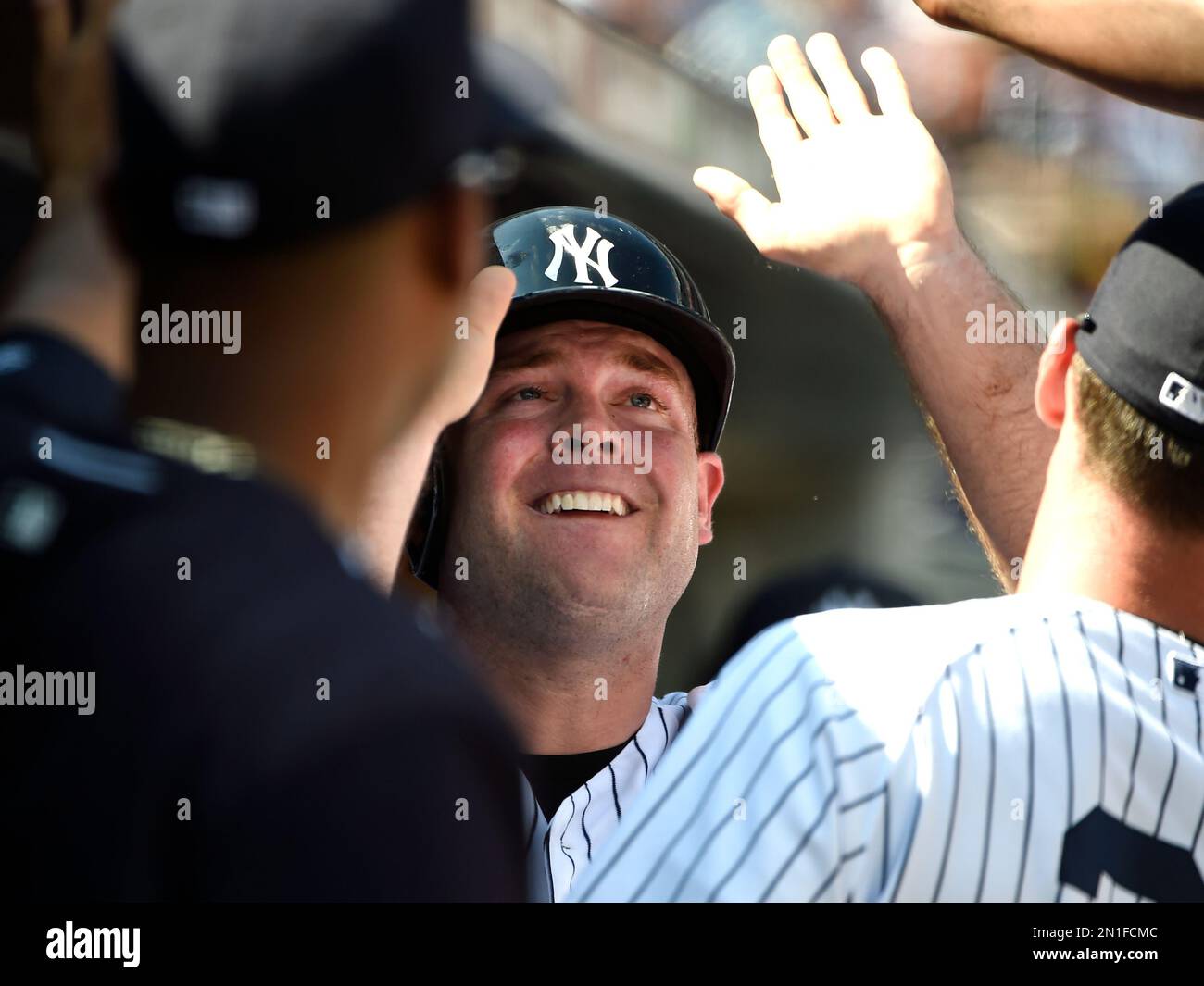 New York Yankees' Brian McCann celebrates with teammates in the dugout ...