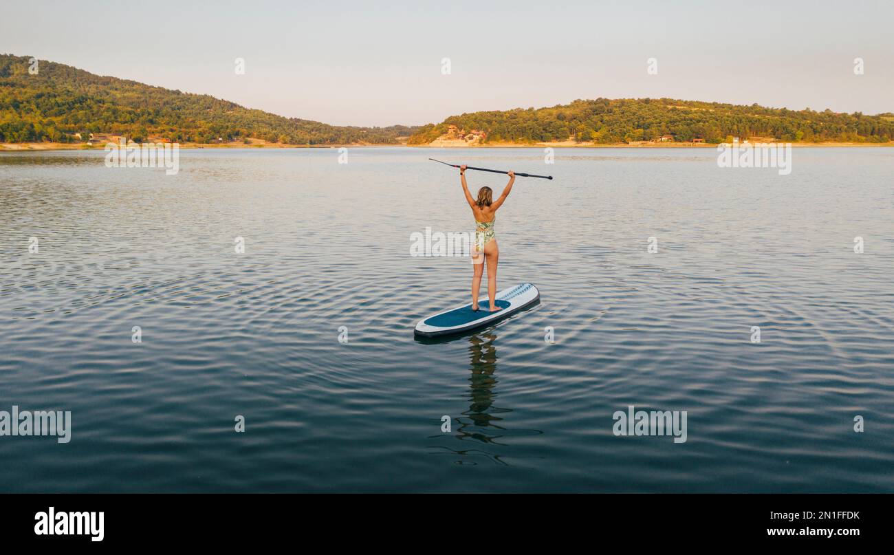 Aerial view of woman riding paddleboard on lake Stock Photo - Alamy
