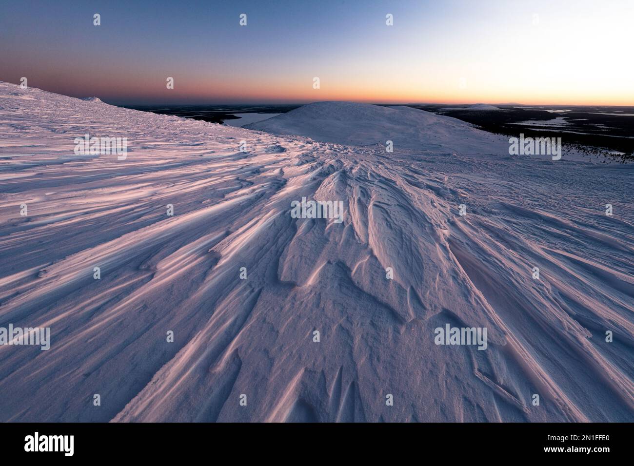 Ice sheets covering the snowy mountains at dusk, Pallas-Yllastunturi ...