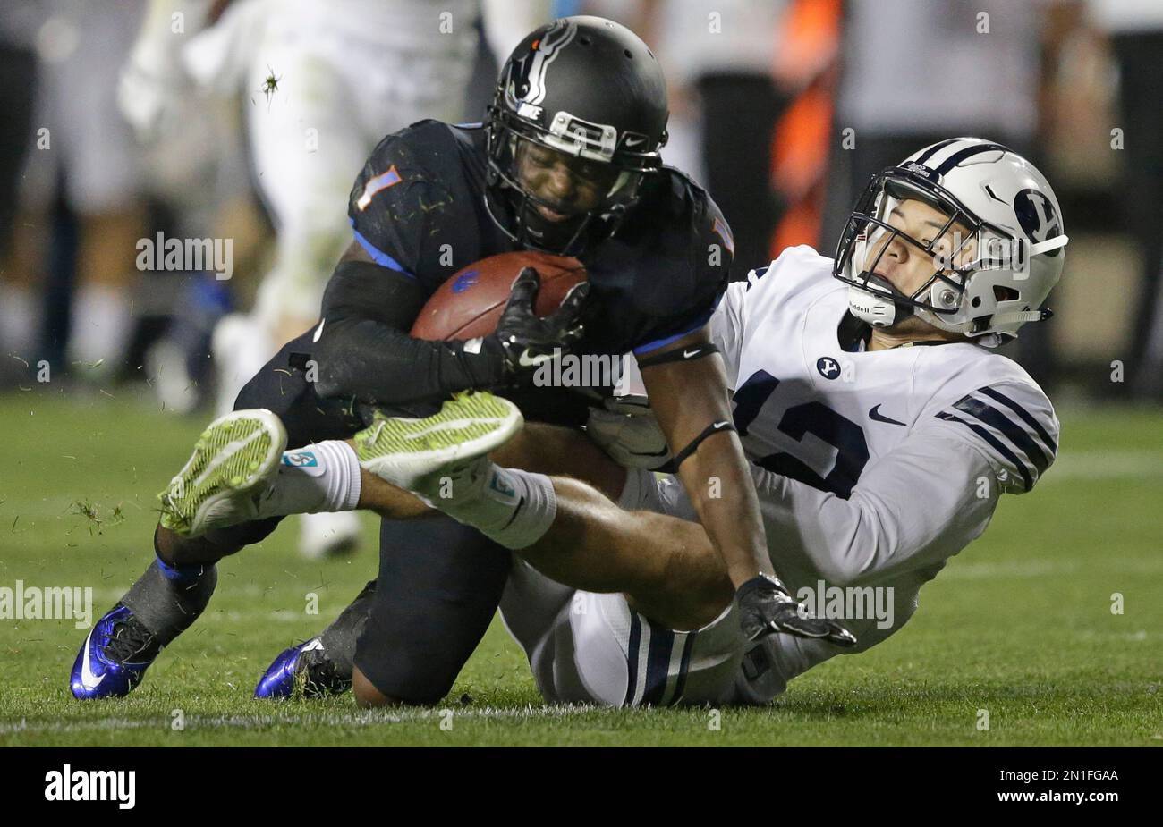Brigham Young defensive back Kai Nacua (12) tackles Boise State wide ...