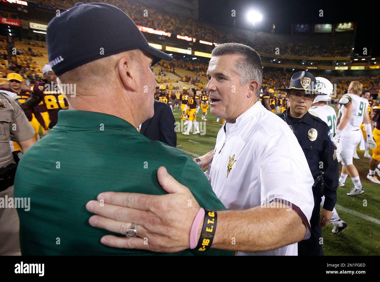 Arizona State head coach Todd Graham, right, talks with Cal Poly head ...