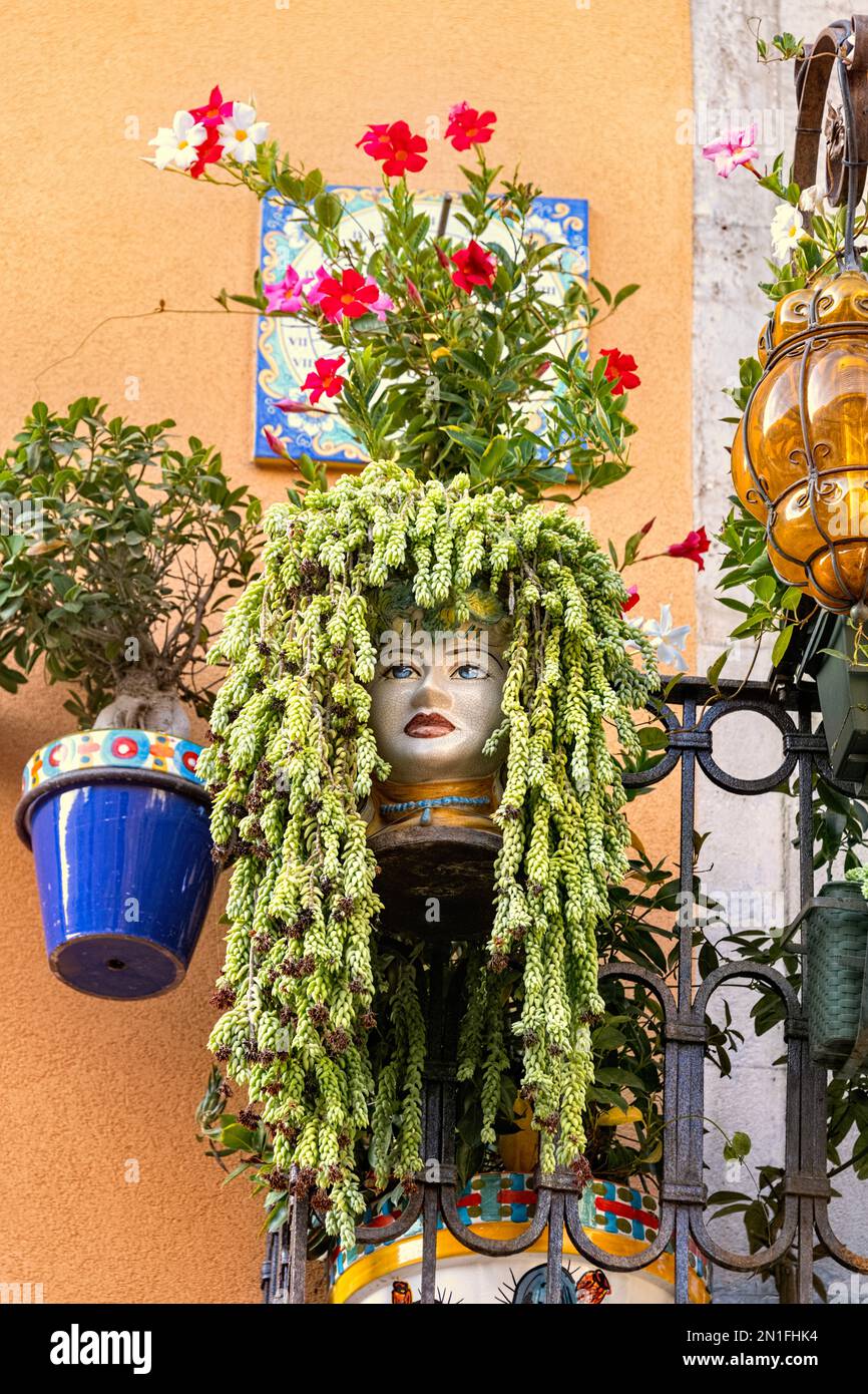 Taormina Sicily, Italy wrought iron balcony festooned with colourful ...