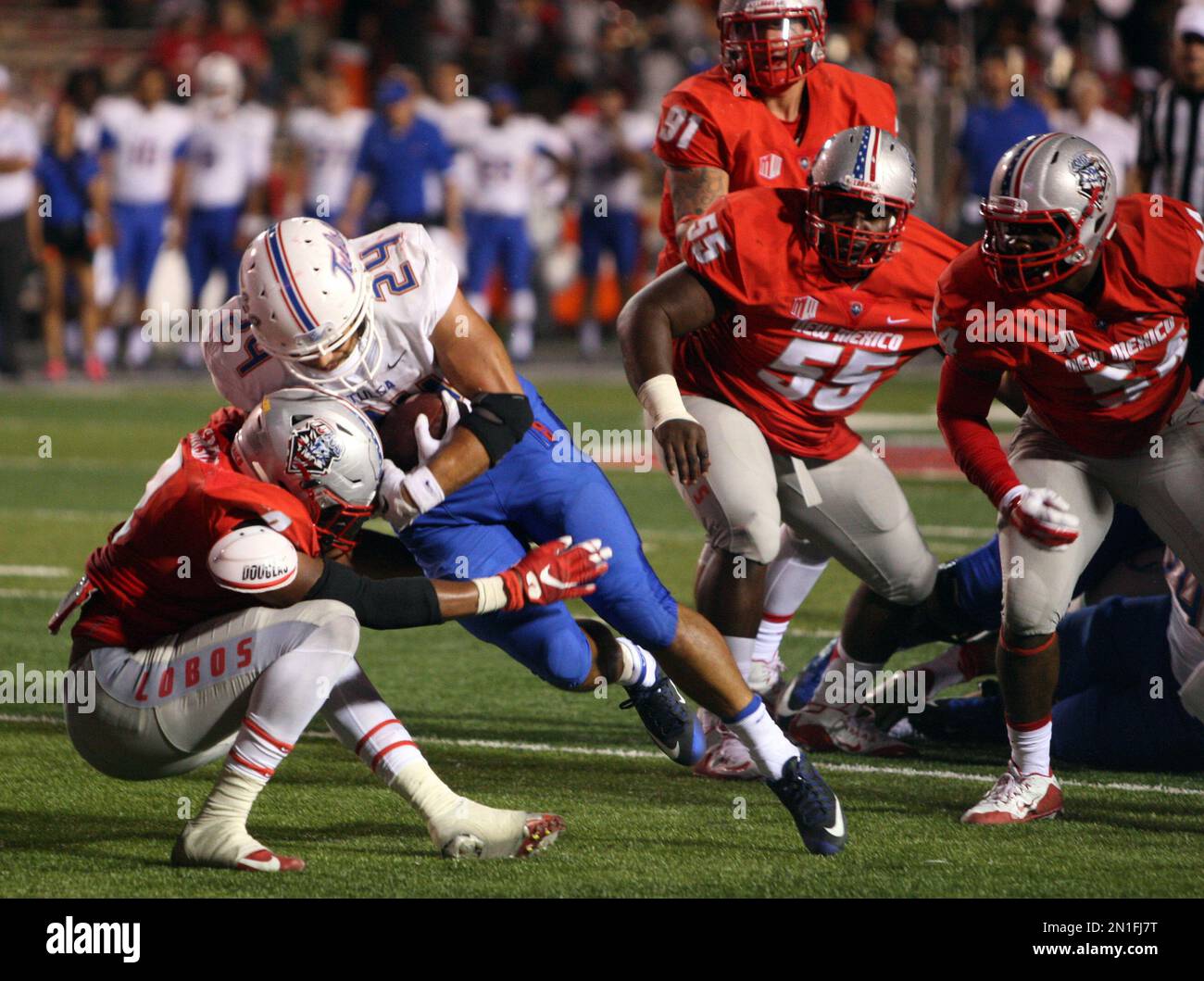 Tulsa's Zack Langer (24) powers over New Mexico's Kimmie Carson (2 ...