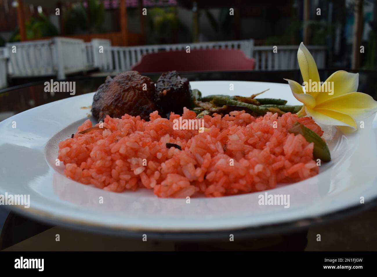 A plate of typical Indonesian oriental fried rice with fried chicken ...