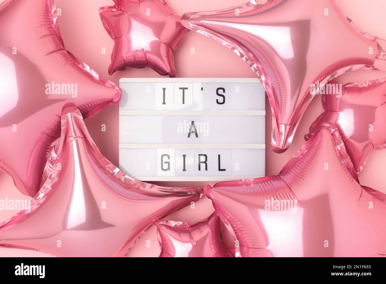 It's a girl. Lightbox with letters and inflatable foil balloons in a ...