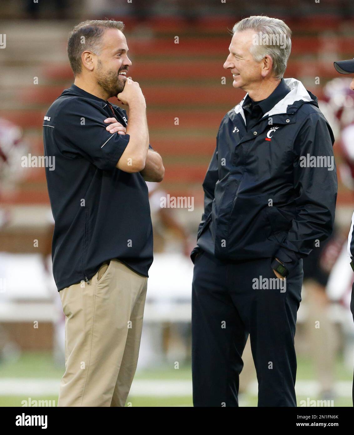 Temple head coach Matt Ruhle, left, and Cincinnati head coach Tommy ...