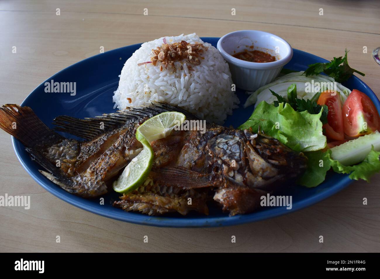 Delicious fried tilapia with white rice served on the table Stock Photo ...