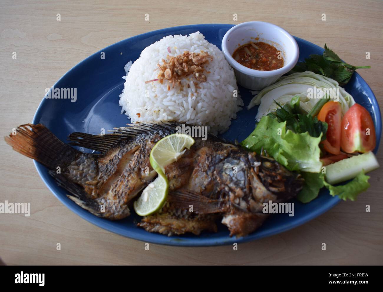 Delicious fried tilapia with white rice served on the table Stock Photo ...