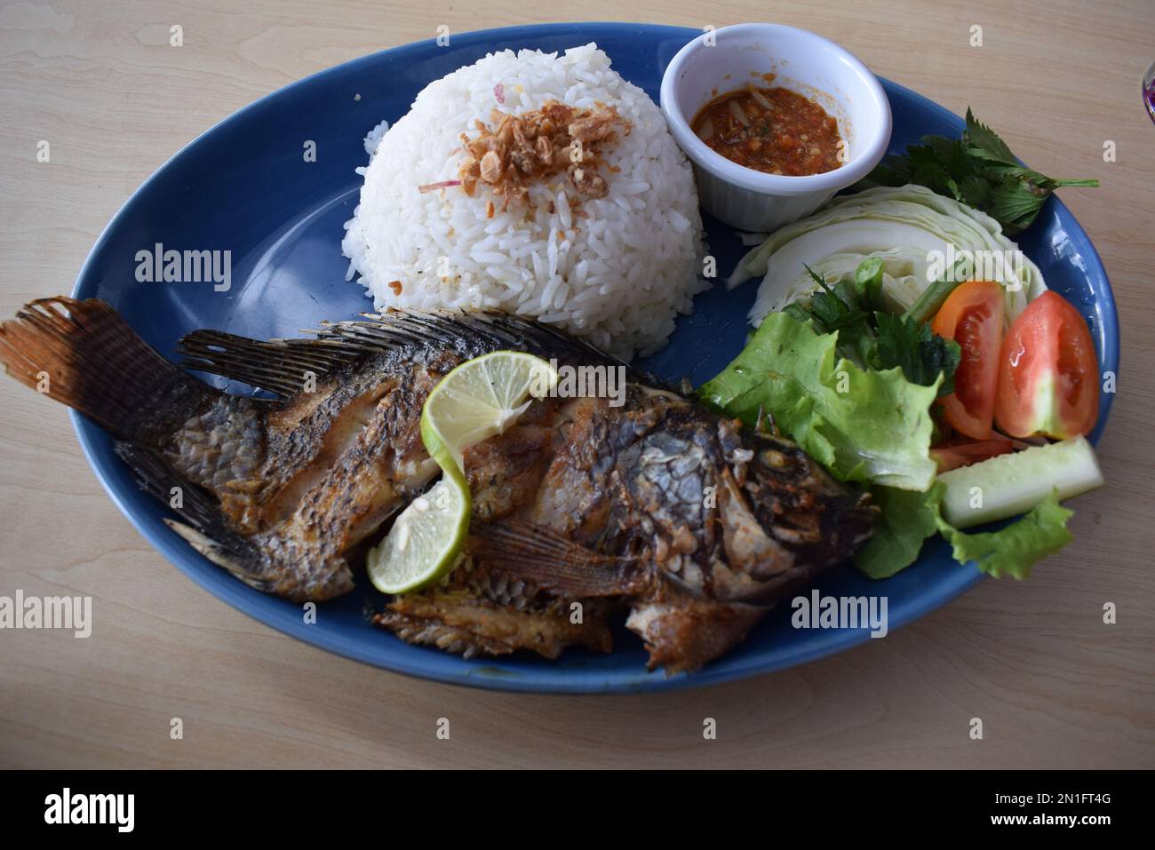 Delicious fried tilapia with white rice served on the table Stock Photo ...