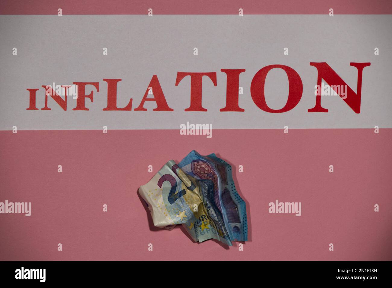 Crumpled 20 Euro banknote on antique pink background and lettering of ...