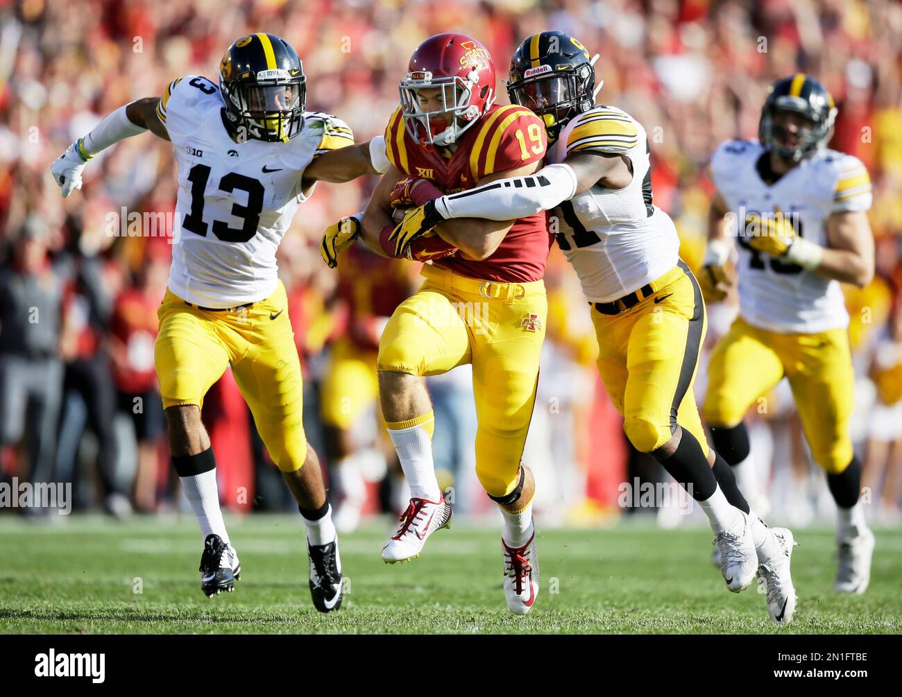Iowa State wide receiver Trever Ryen (19) runs from Iowa defenders Greg ...