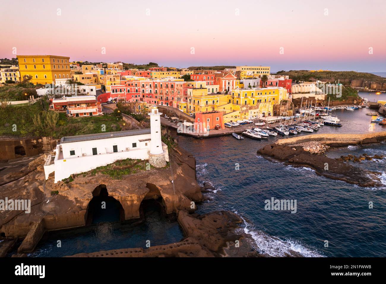 Lighthouse and the colourful village of Ventotene at dawn, Pontine ...