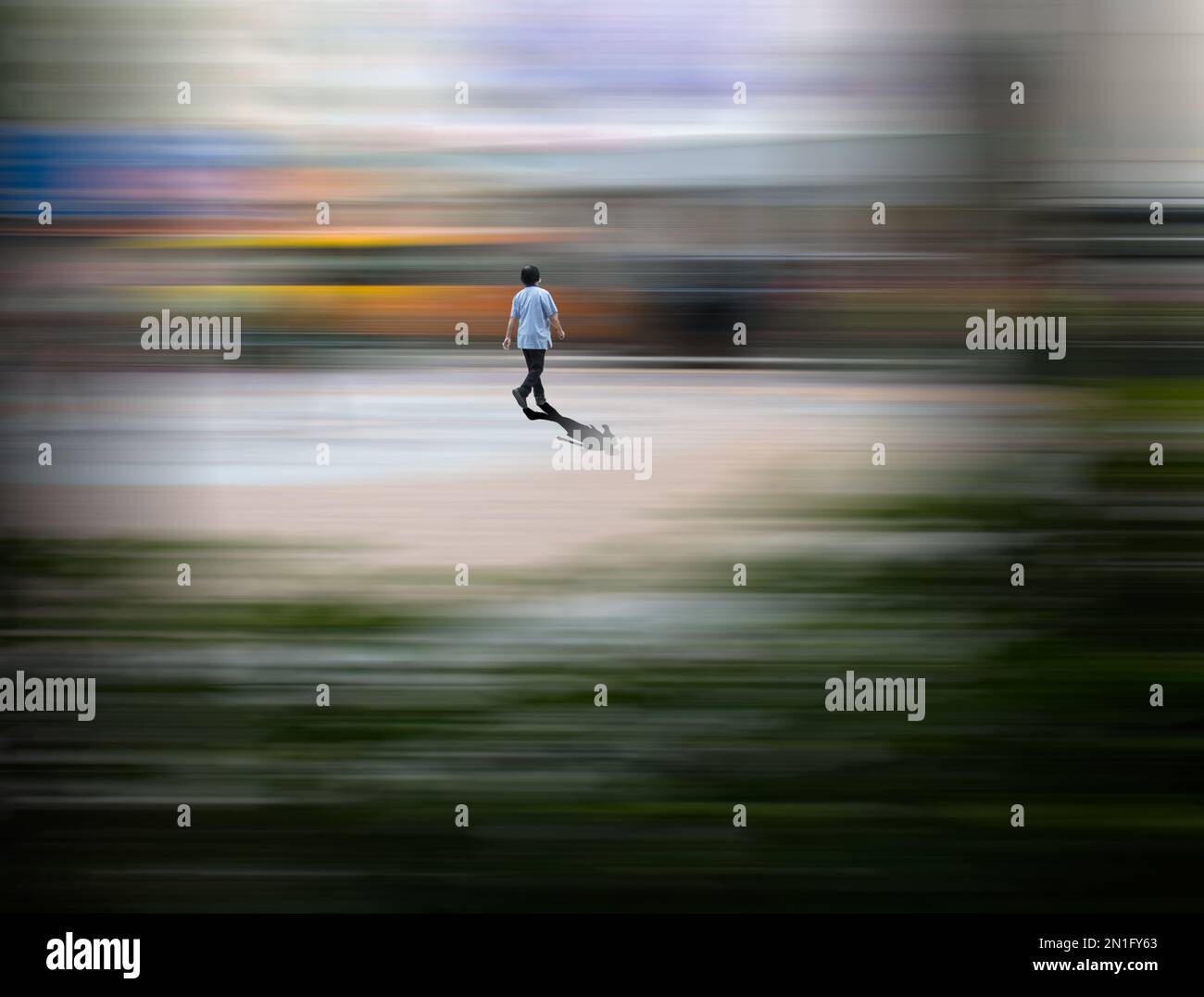 A person walks across a small square. A path blur is used for an ...