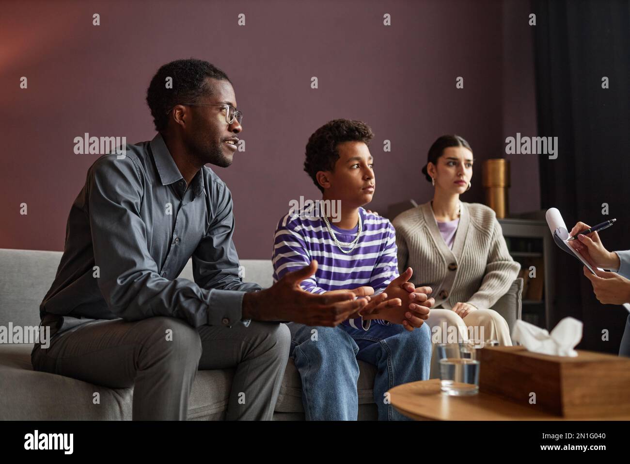 Family with teenage boy explaining problems to psychologist Stock Photo ...