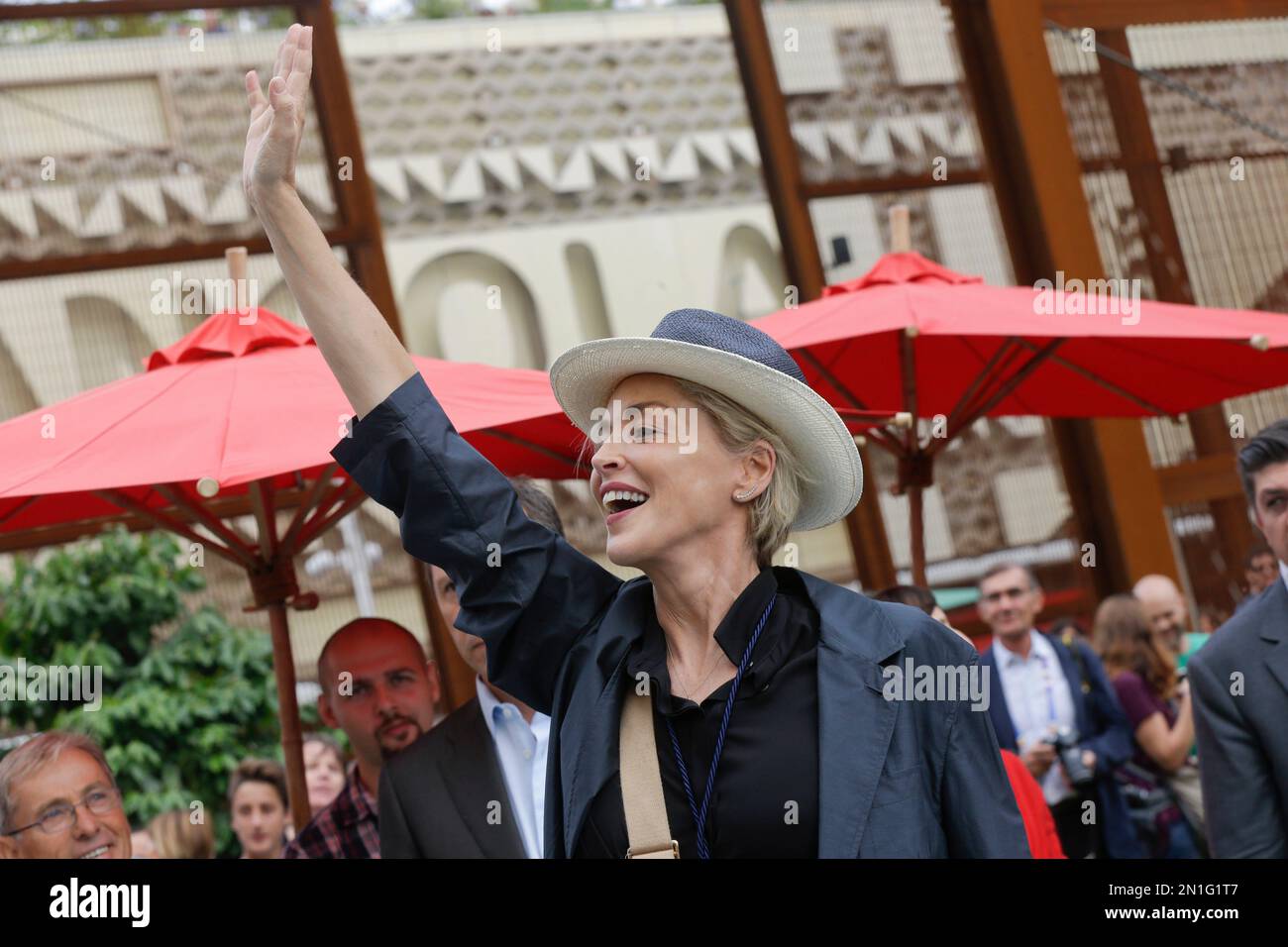 Actress Sharon Stone waves as she visits the Save the Children pavilion ...