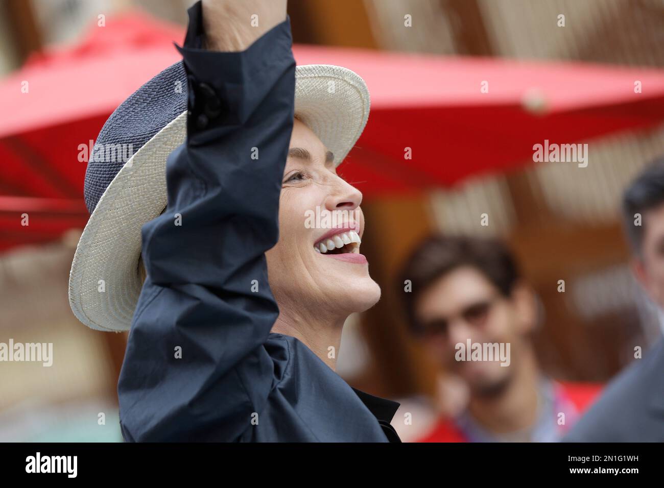 Actress Sharon Stone waves as she visits the Save the Children pavilion ...
