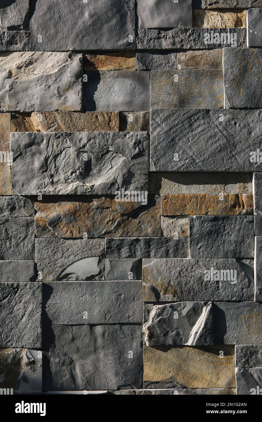 Stone wall in sunlight. Sharp shadows emphasize the textere. Different ...