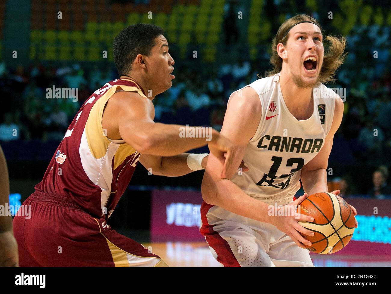 Canada's Kelly Olynyk, left, looks to shoot under pressure from ...