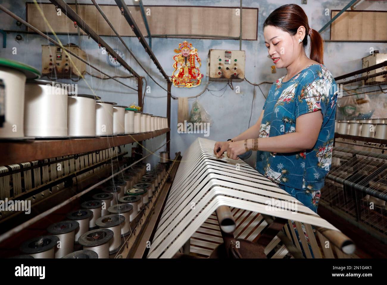 Woman working in a traditional silk factory, Tan Chau, Vietnam, Indochina, Southeast Asia, Asia ...