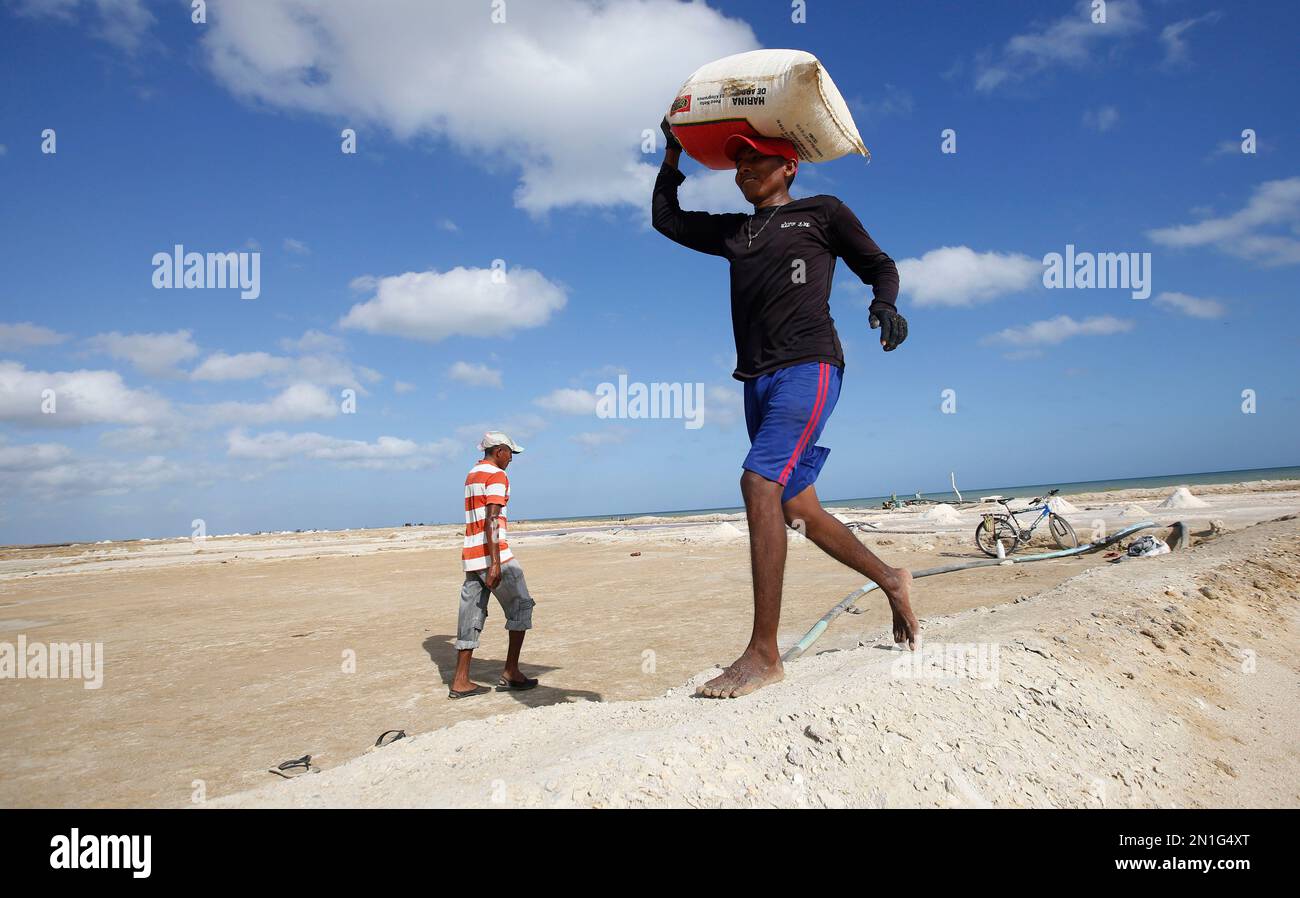 In this Sept. 9, 2015 photo, a Wayuu indigenous man carries a sack of ...