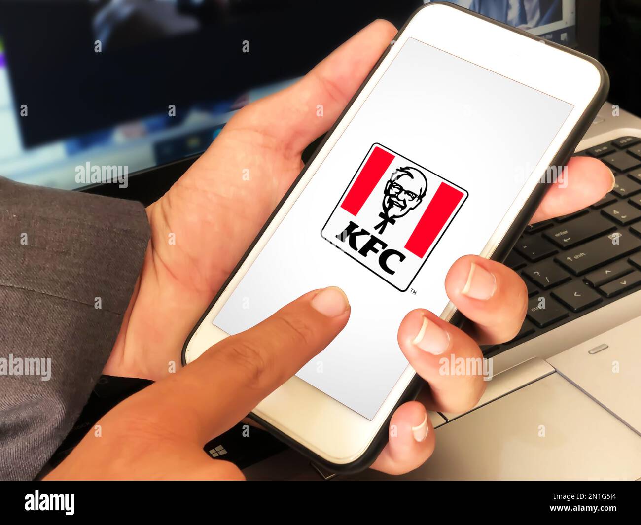 Mobile food ordering application KFC with man touching the screen ...