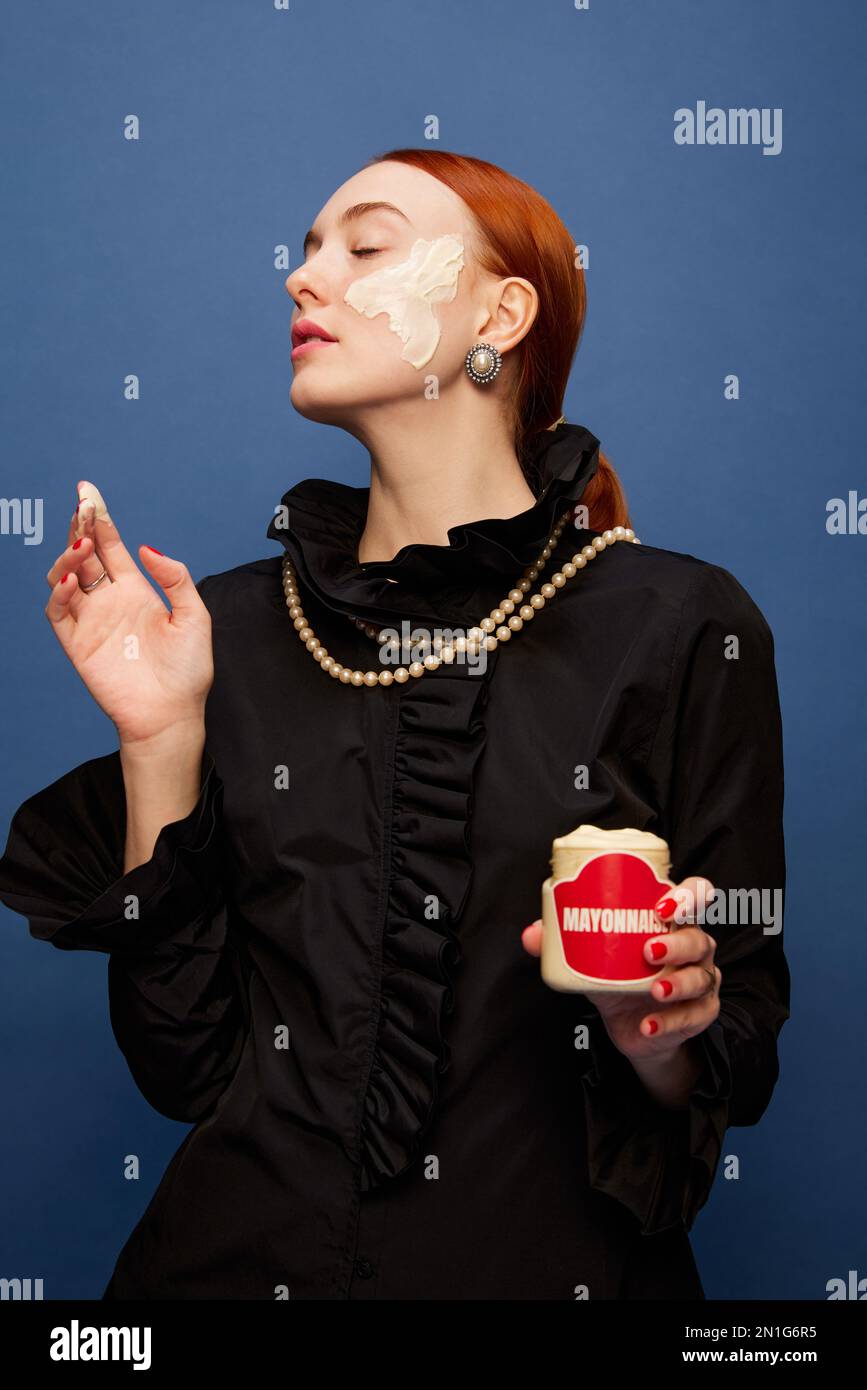 Natural taste of sauce. Beautiful young girl with mayonnaise on face ...