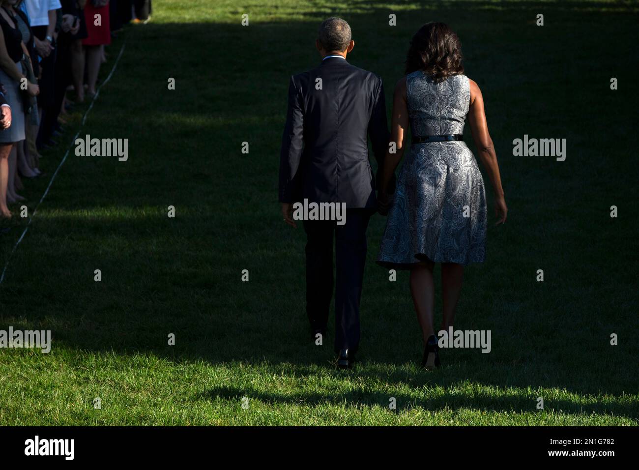 President Barack Obama and first lady Michelle Obama walk off the South ...