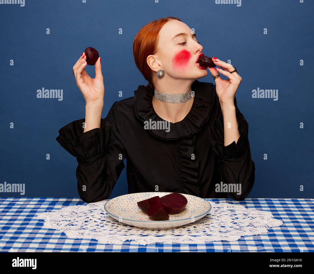 Source of complex carbohydrates. Young beautiful girl eating beet over ...