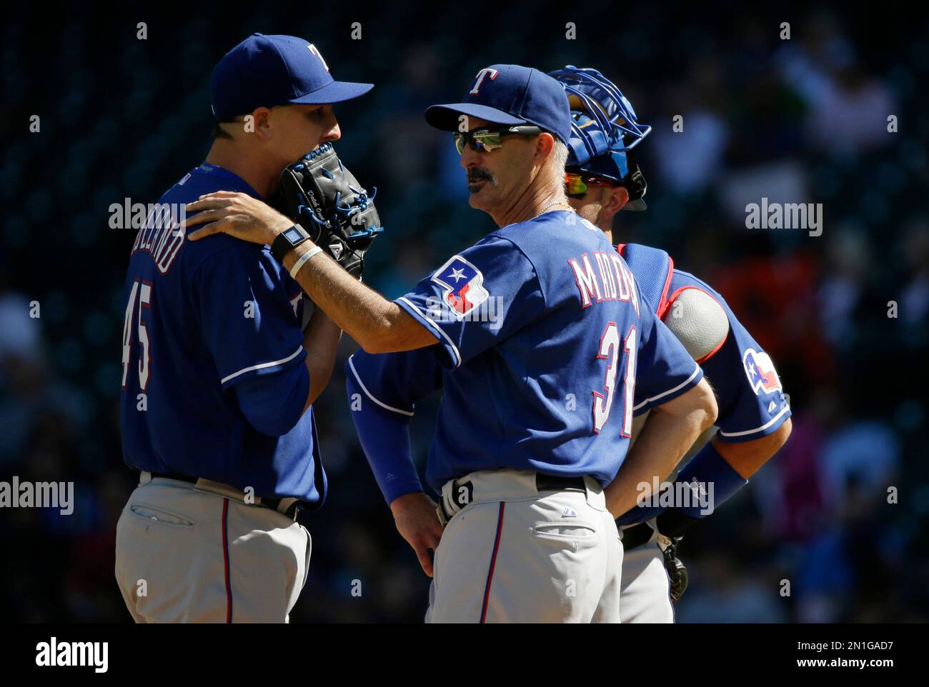 Texas Rangers pitching coach Mike Maddux, center talks with starting ...